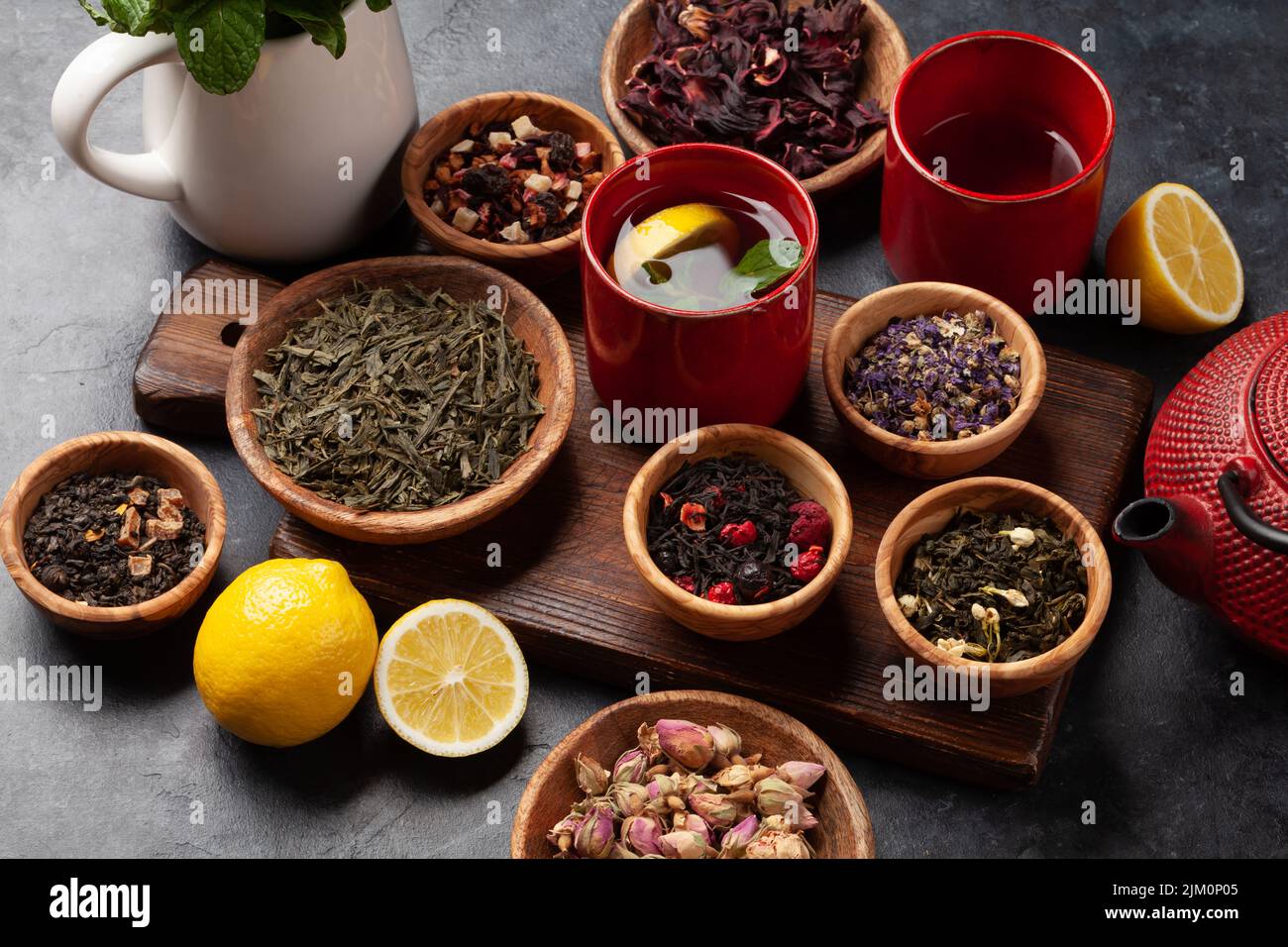 Various dried tea and teapot. Top view Stock Photo - Alamy