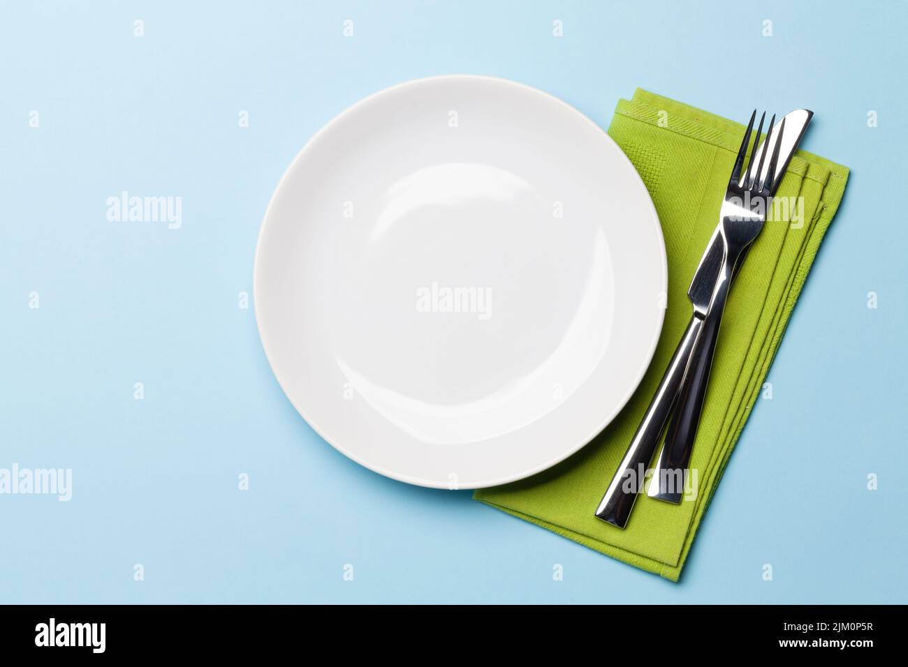 Empty plate and silverware. Top view flat lay with copy space. Template ...