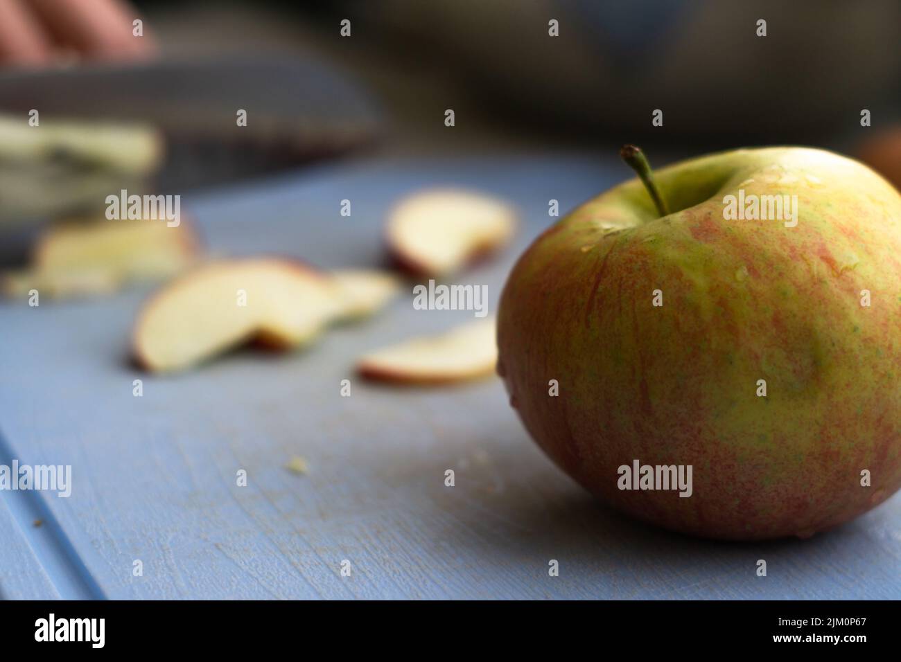 A close up slicing apple on a chopping board Stock Photo - Alamy