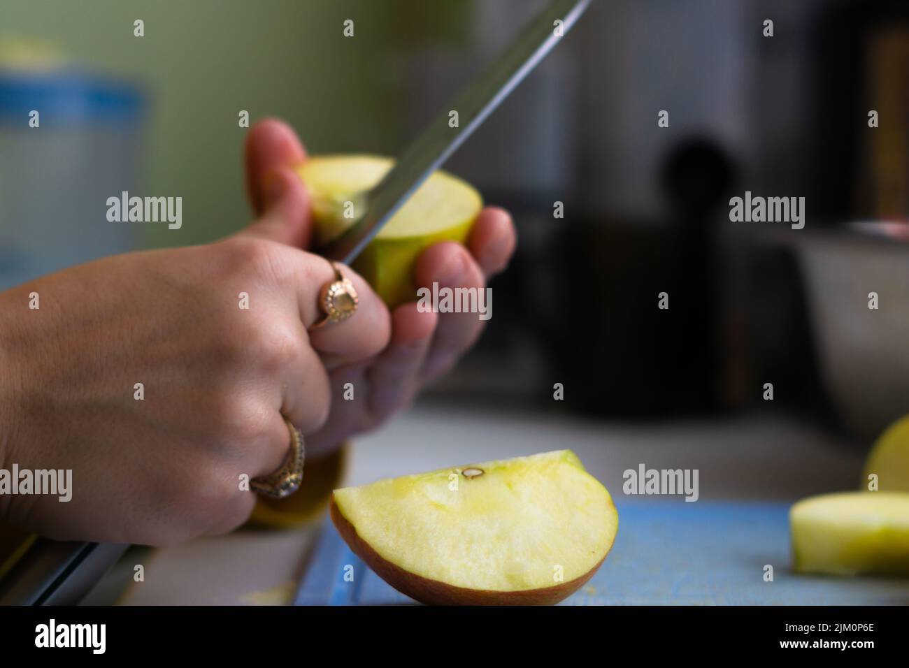 A close up slicing apple on a chopping board Stock Photo - Alamy