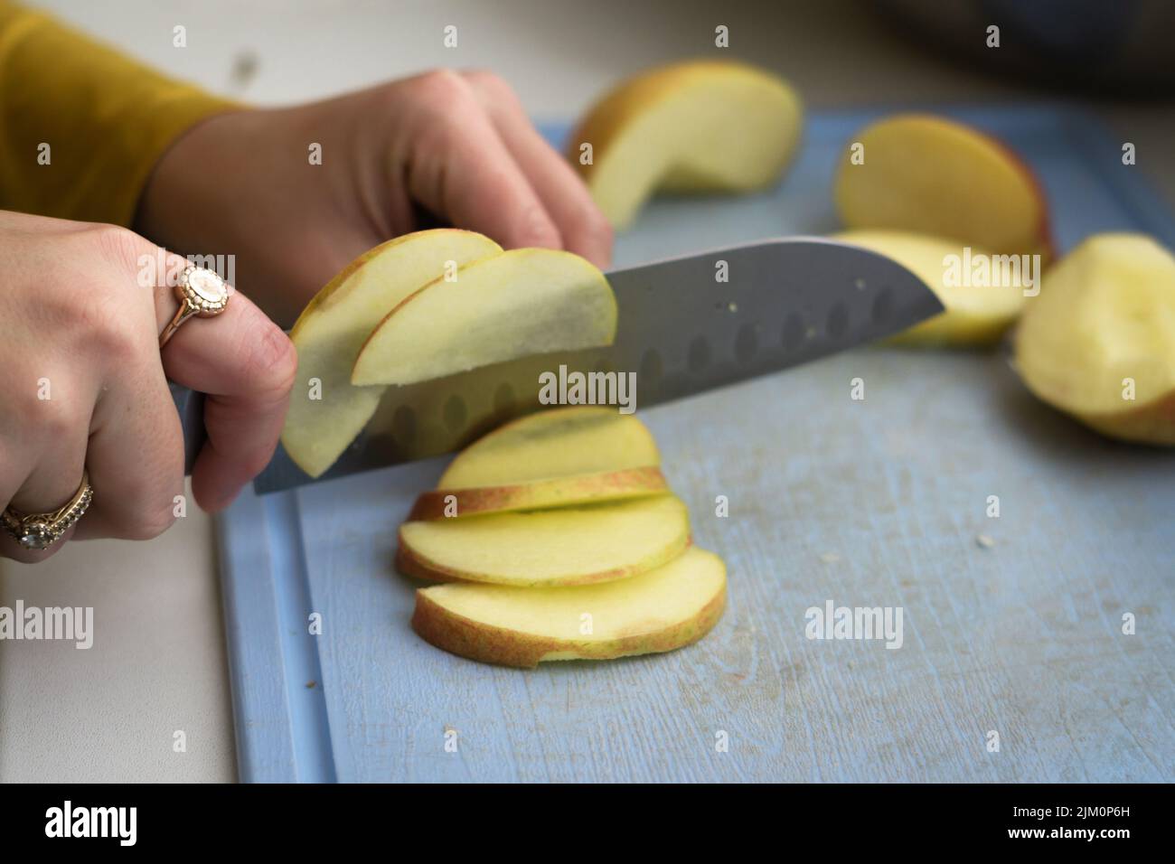 A close up slicing apple on a chopping board Stock Photo - Alamy