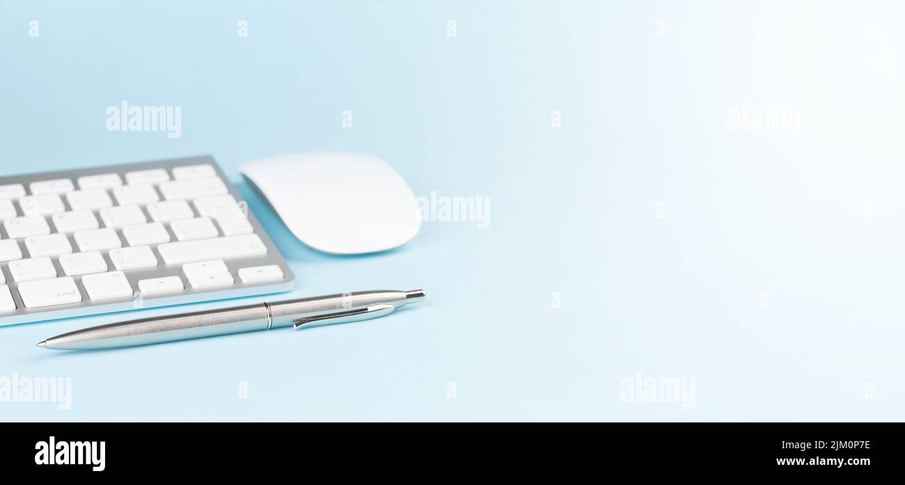Pc keyboard, mouse and pen on blue background with copy space Stock ...