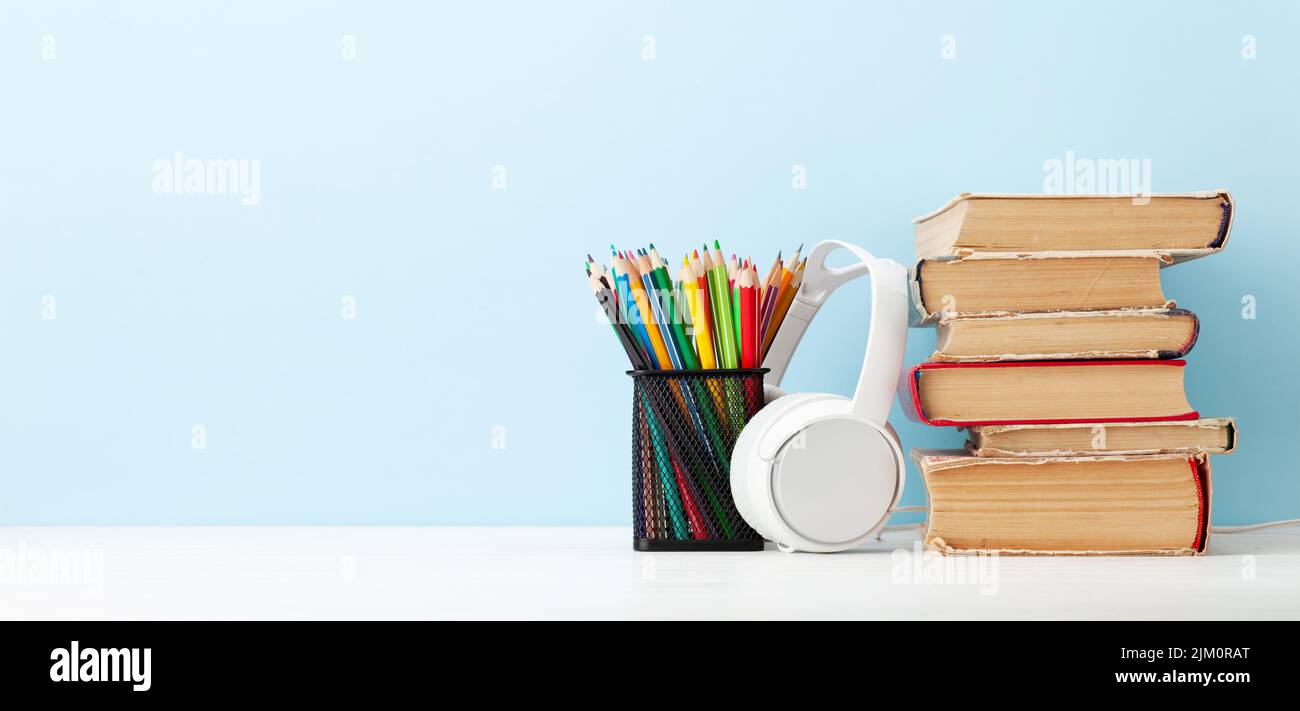 Old books, headphones and pencils on wooden table and copy space ...