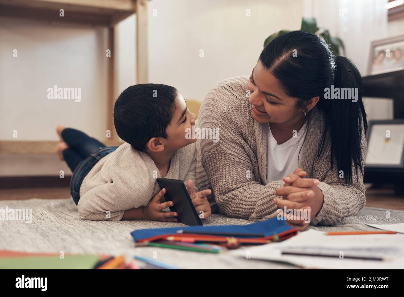 With Moms love, I can learn anything. an adorable little boy using a ...