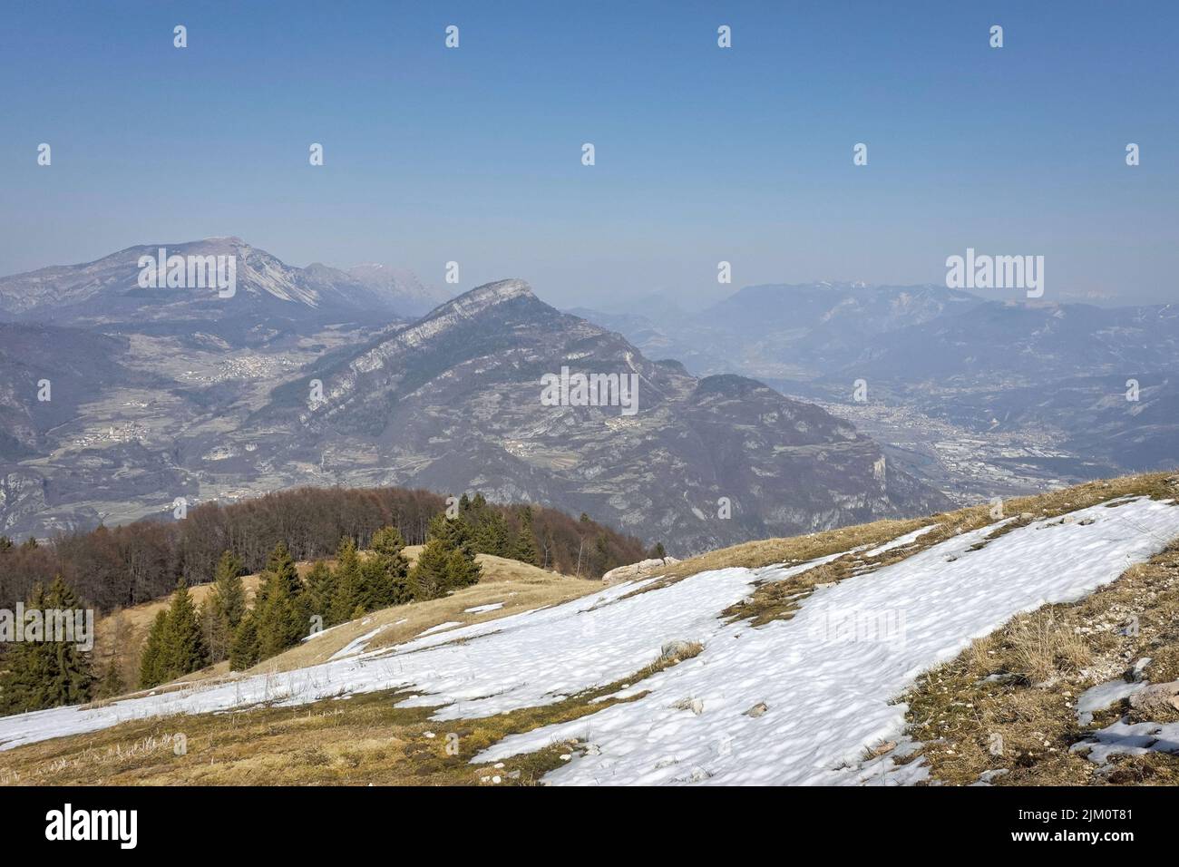 A bright morning day in the mountains with a thin layer of snow on the ...