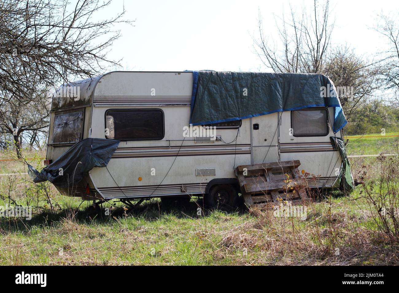 An abandoned trailer stands in a meadow and decays Stock Photo - Alamy