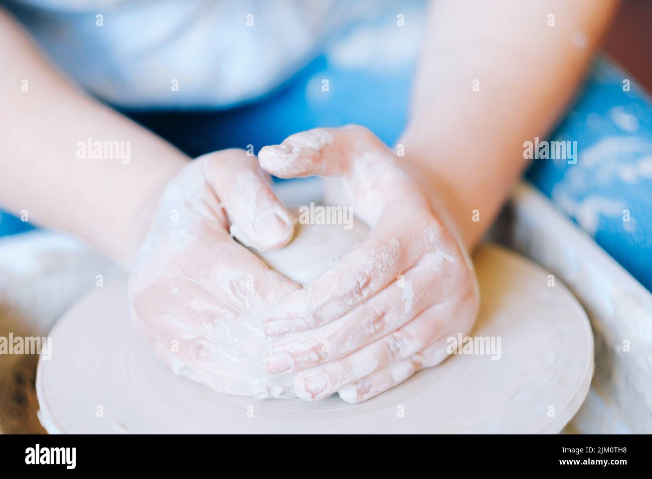 pottery handcraft hobby hands shape clay wheel Stock Photo - Alamy