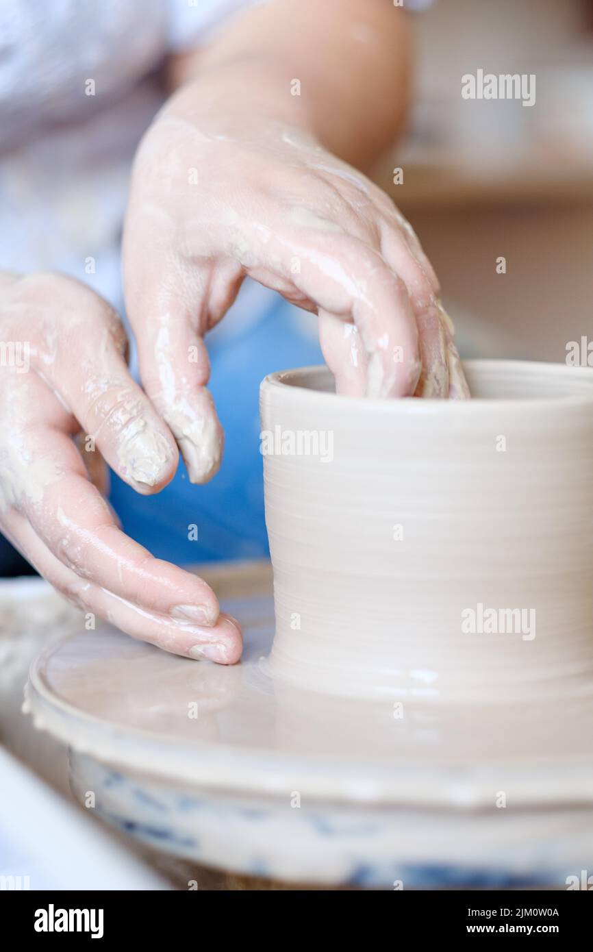 pottery handcraft hobby hands shape clay wheel Stock Photo - Alamy