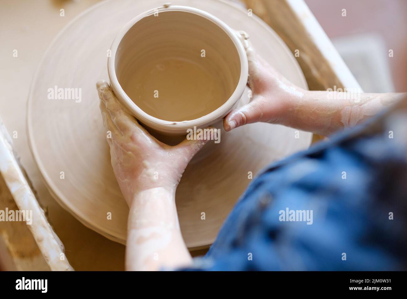 pottery handcraft hobby hands shape clay wheel Stock Photo - Alamy