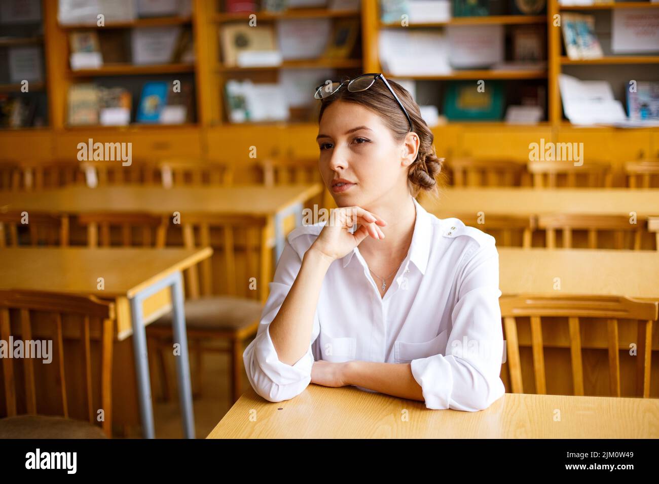 Young female student in white shirt in school class, youth education ...