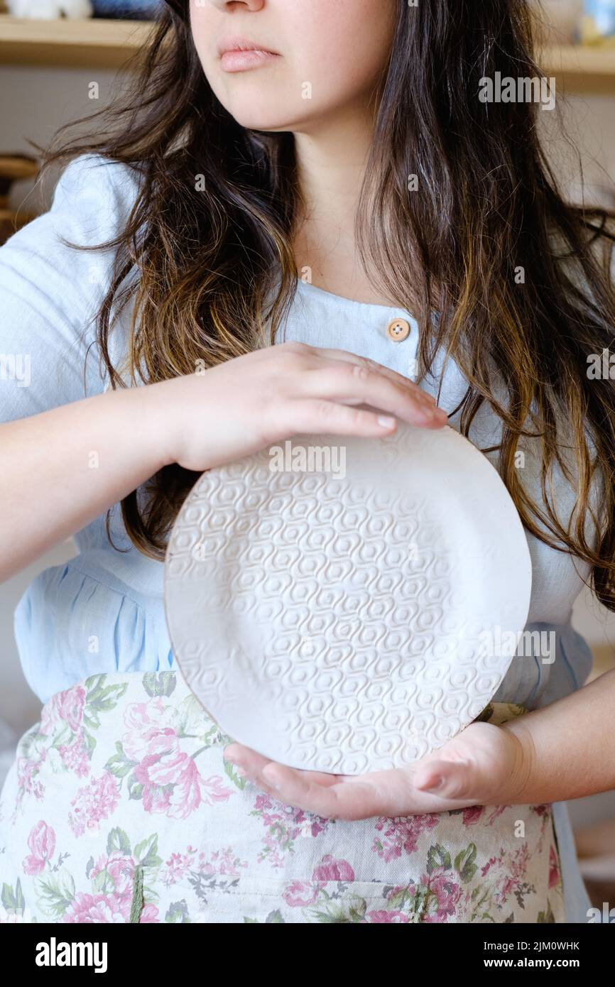 pottery skill traditional hold clay plate crockery Stock Photo - Alamy