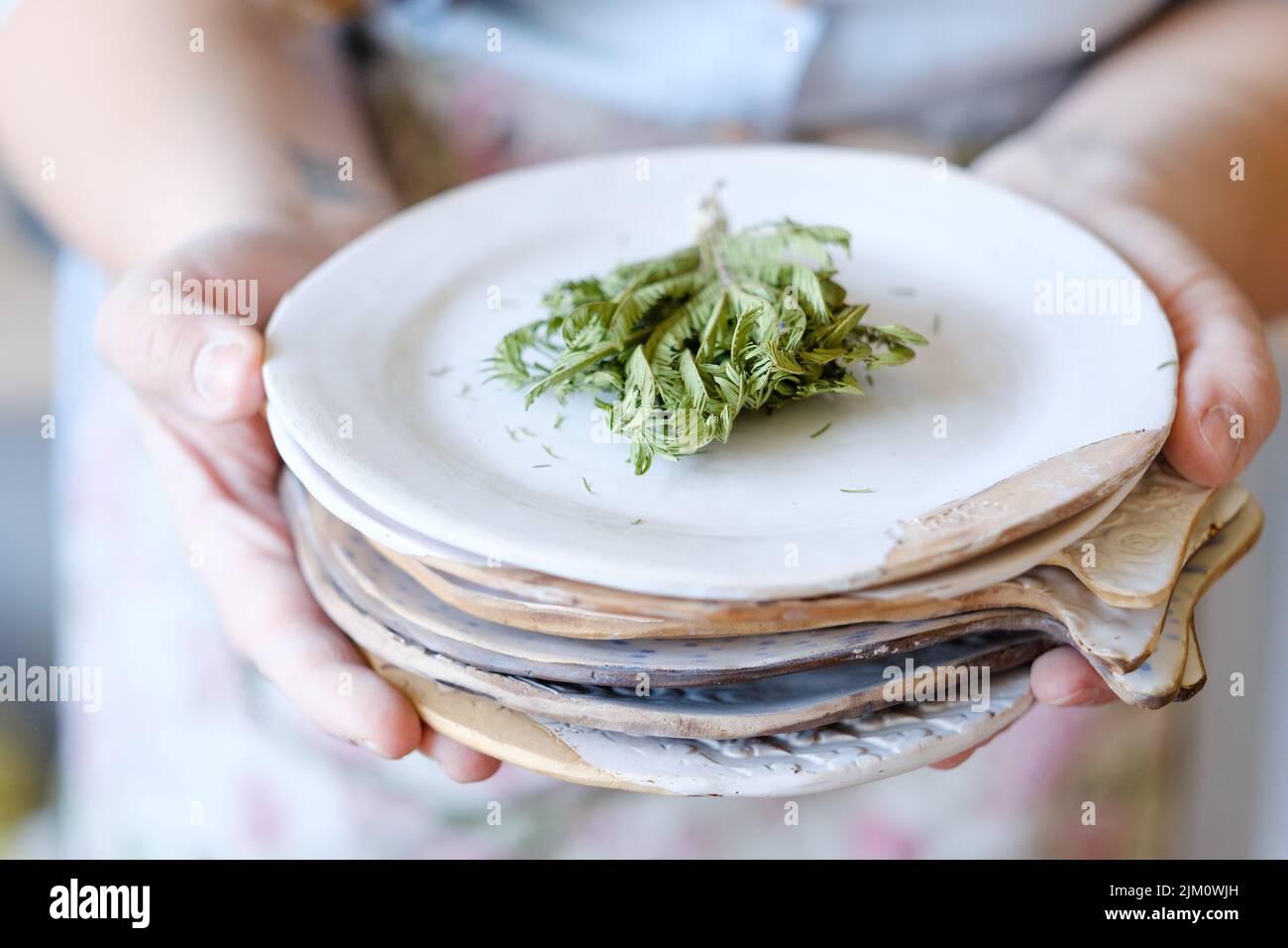 pottery skill traditional hold clay plate crockery Stock Photo - Alamy