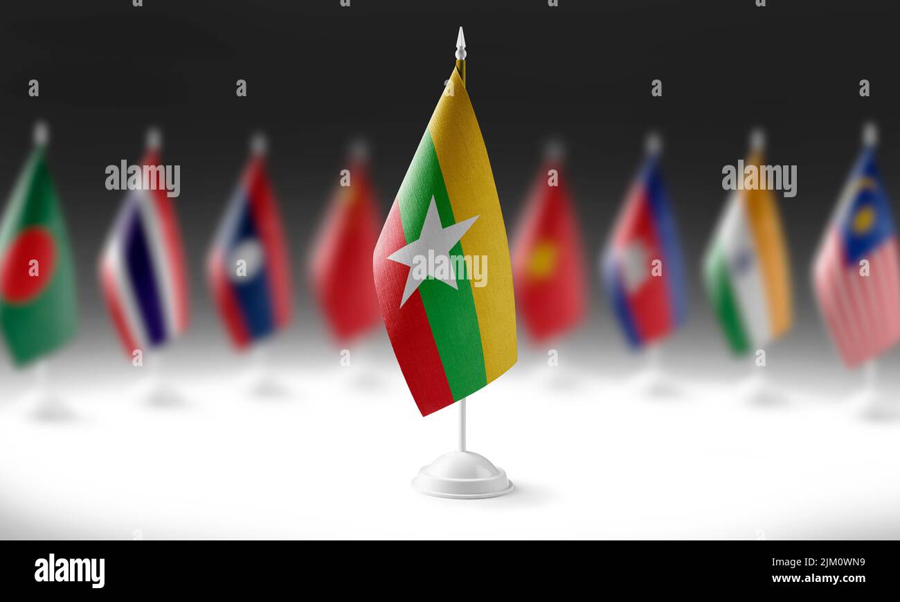 The national flag of the Myanmar on the background of flags of other ...
