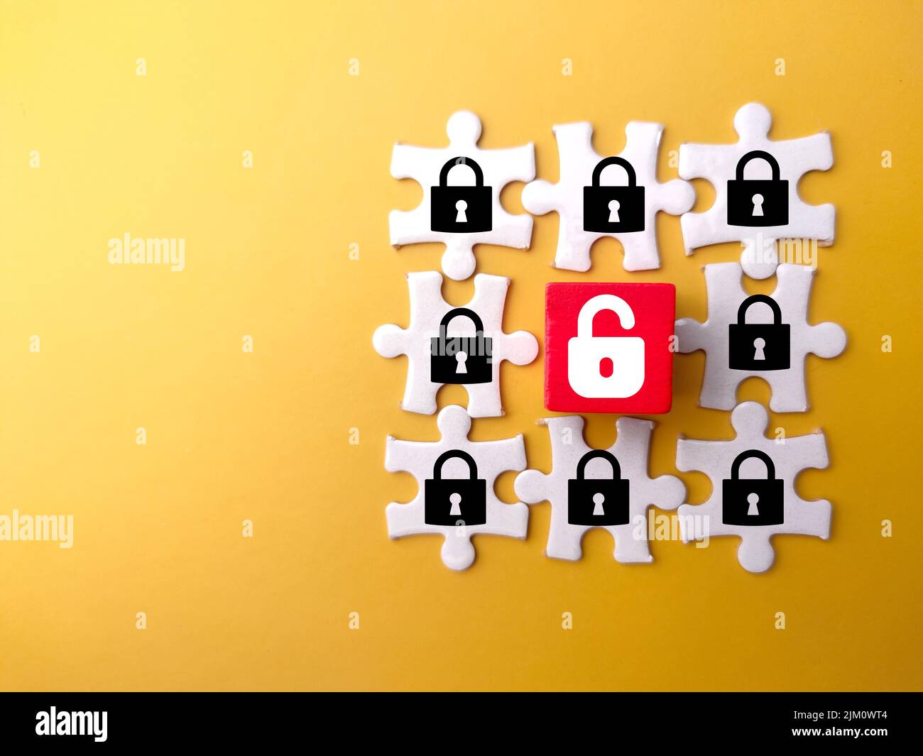 White puzzle with lock and unlock icons on red wooden cube. The concept ...
