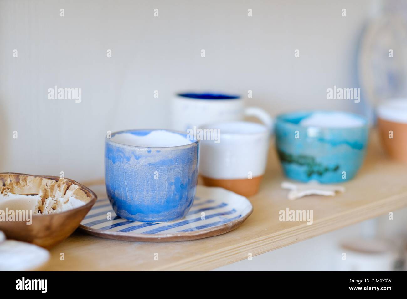 pottery handcraft hobby clay mugs jugs assortment Stock Photo - Alamy