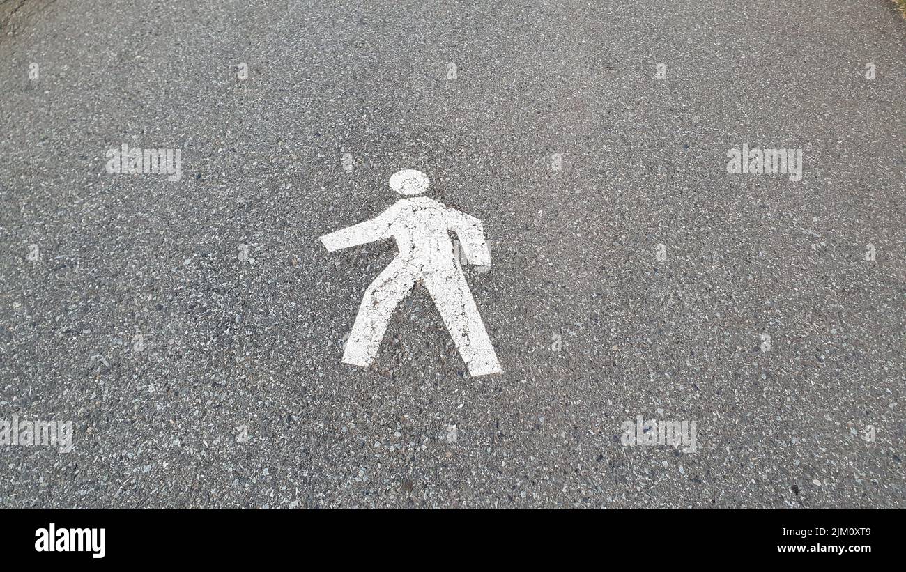 White pedestrian sign on gray tiles Stock Photo - Alamy