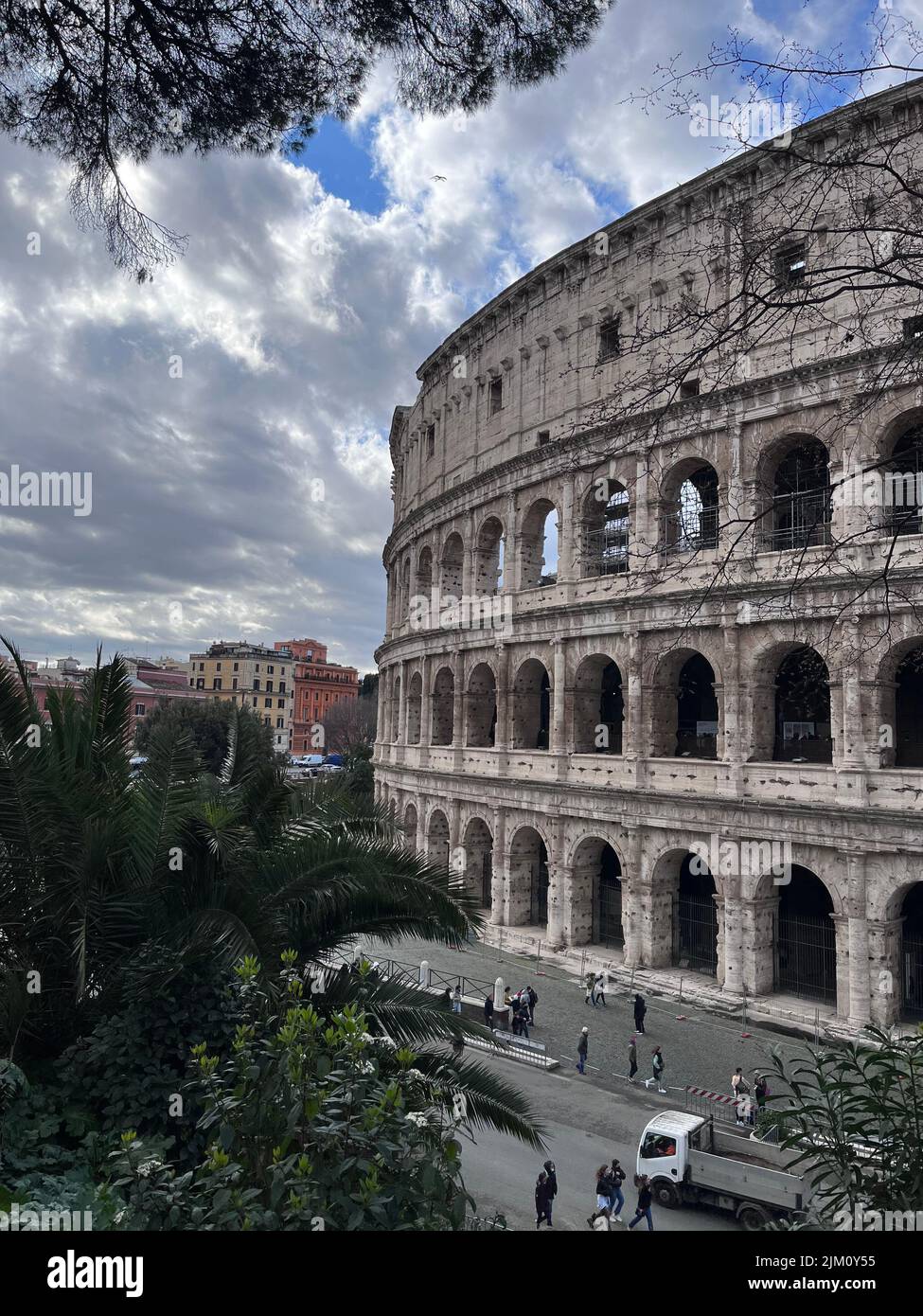 A low angle shot of an ancient building Coliseum in Italy Stock Photo ...