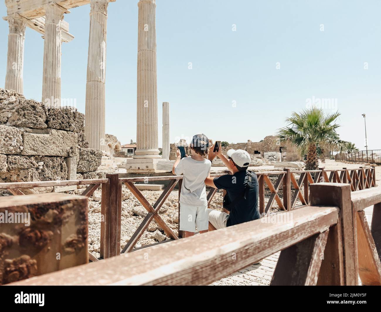 Young father dad and his school boy kid son tourists taking photos of ...