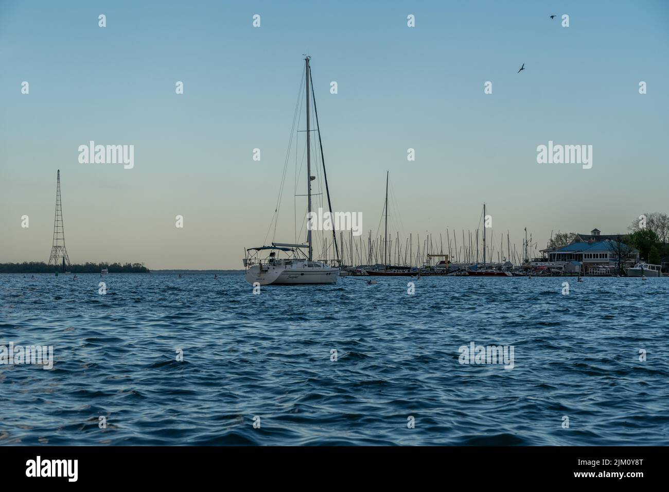 A boat floating on the sea on the sunset Stock Photo - Alamy