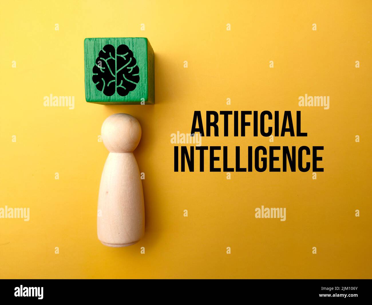 Wooden figures and colored block with brain icon and the word ...