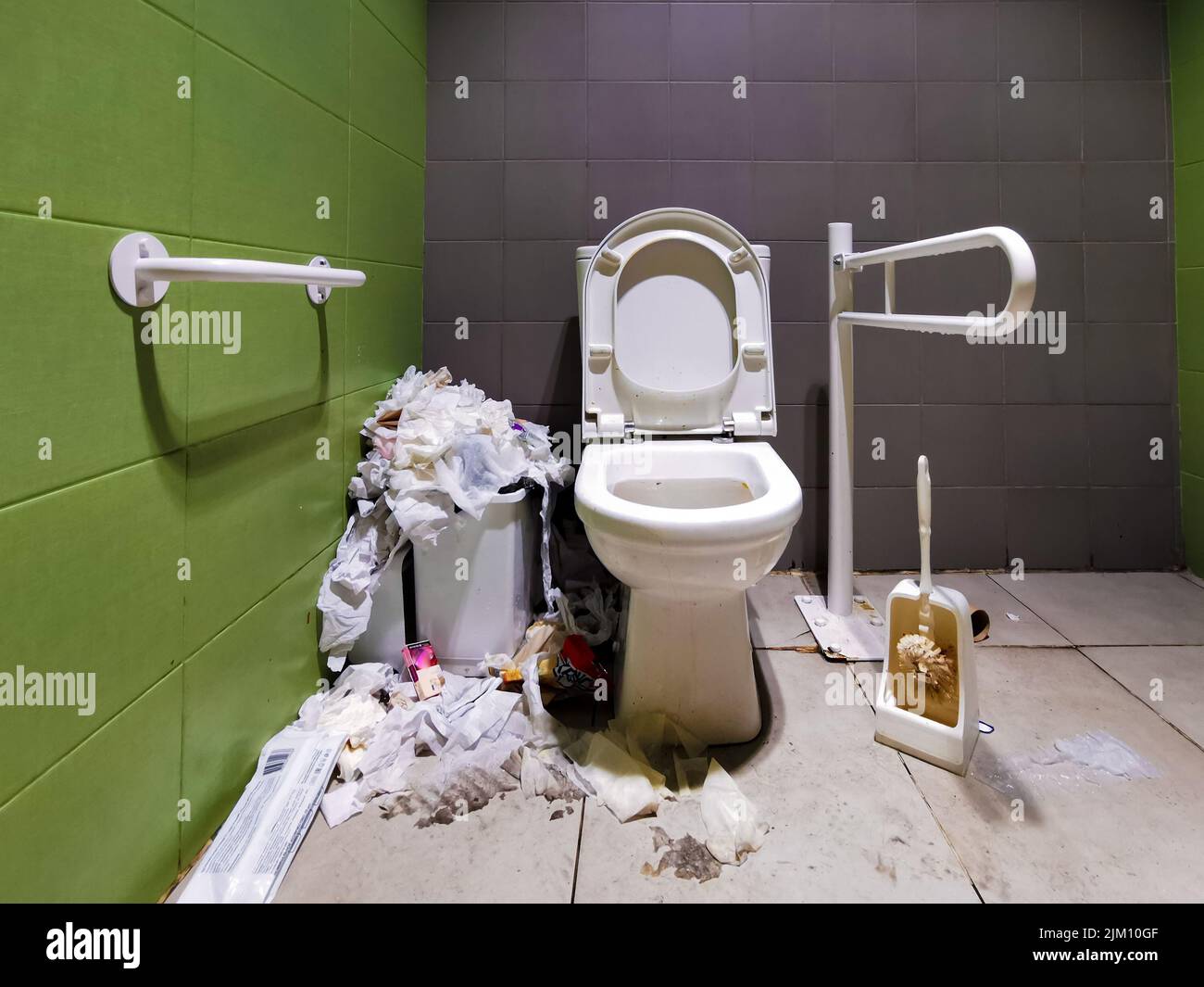 Dirty uncleaned public toilet for the disabled with an overflowing ...