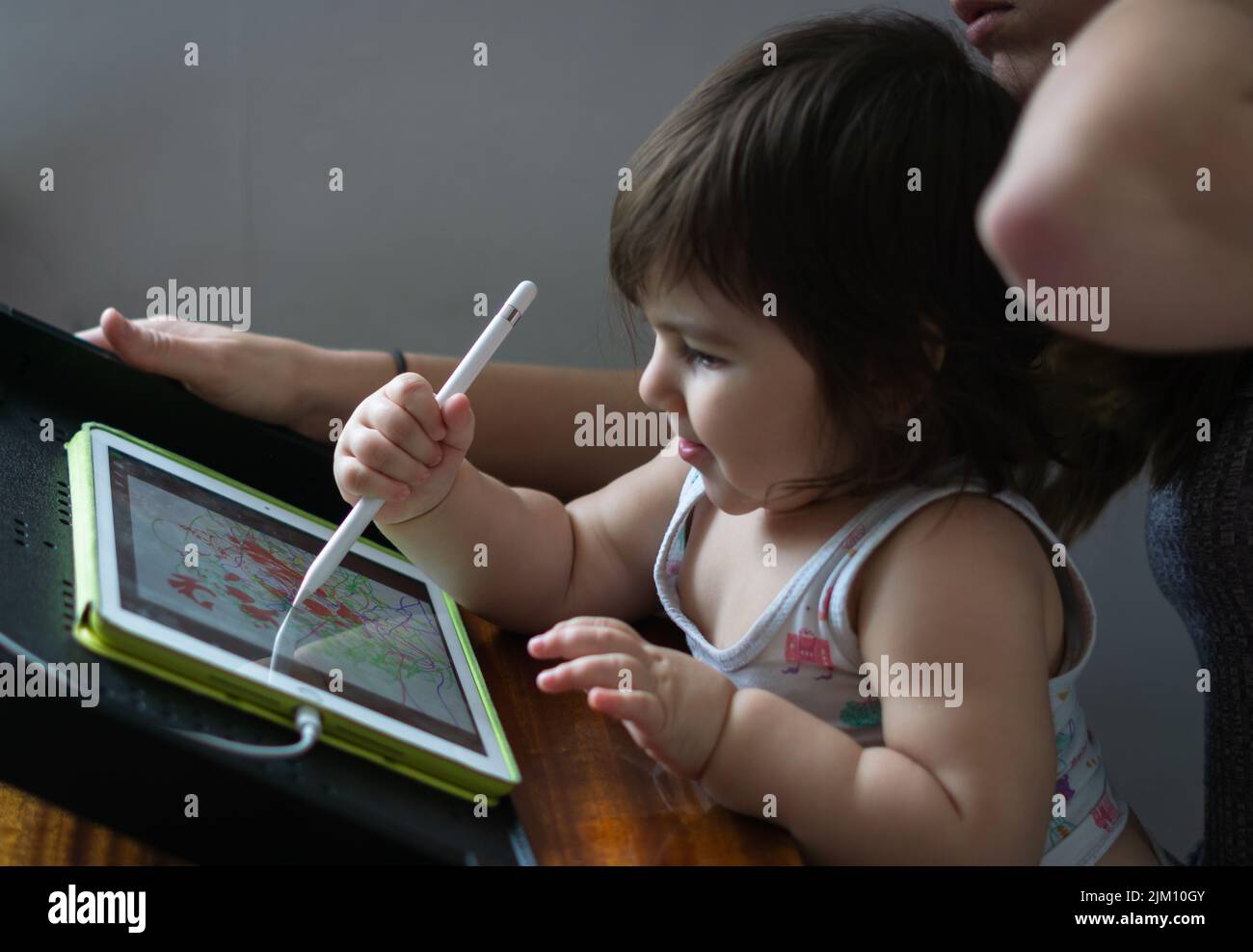A close up woman with her daughter creating digital drawing Stock Photo ...