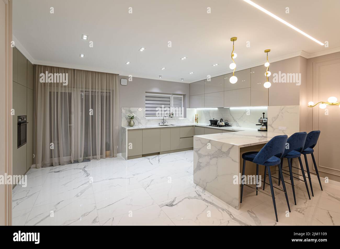 Luxury white modern marble kitchen in studio space Stock Photo - Alamy