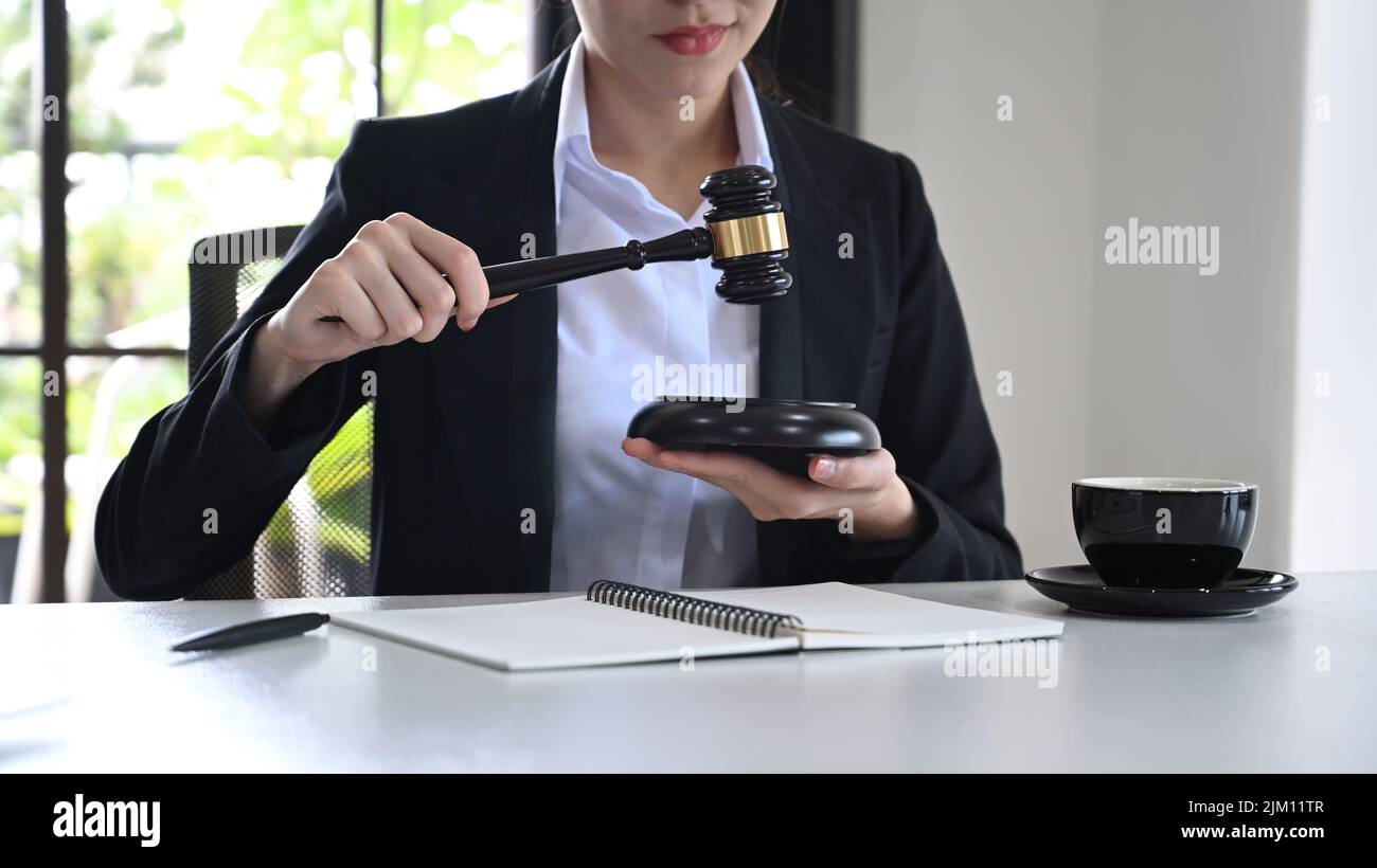 Female judge or lawyer holding a gavel in her hand. Legal law, advice ...