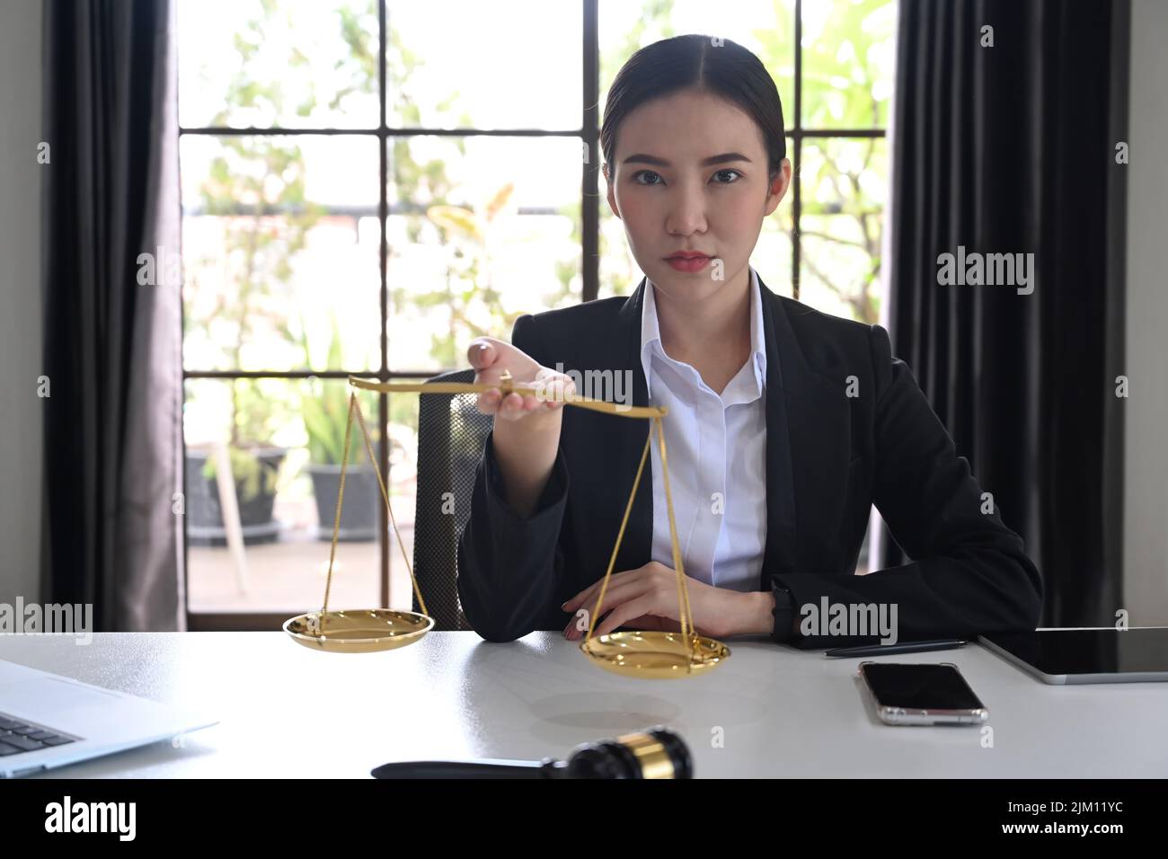 Woman holding justice scale hi-res stock photography and images - Alamy