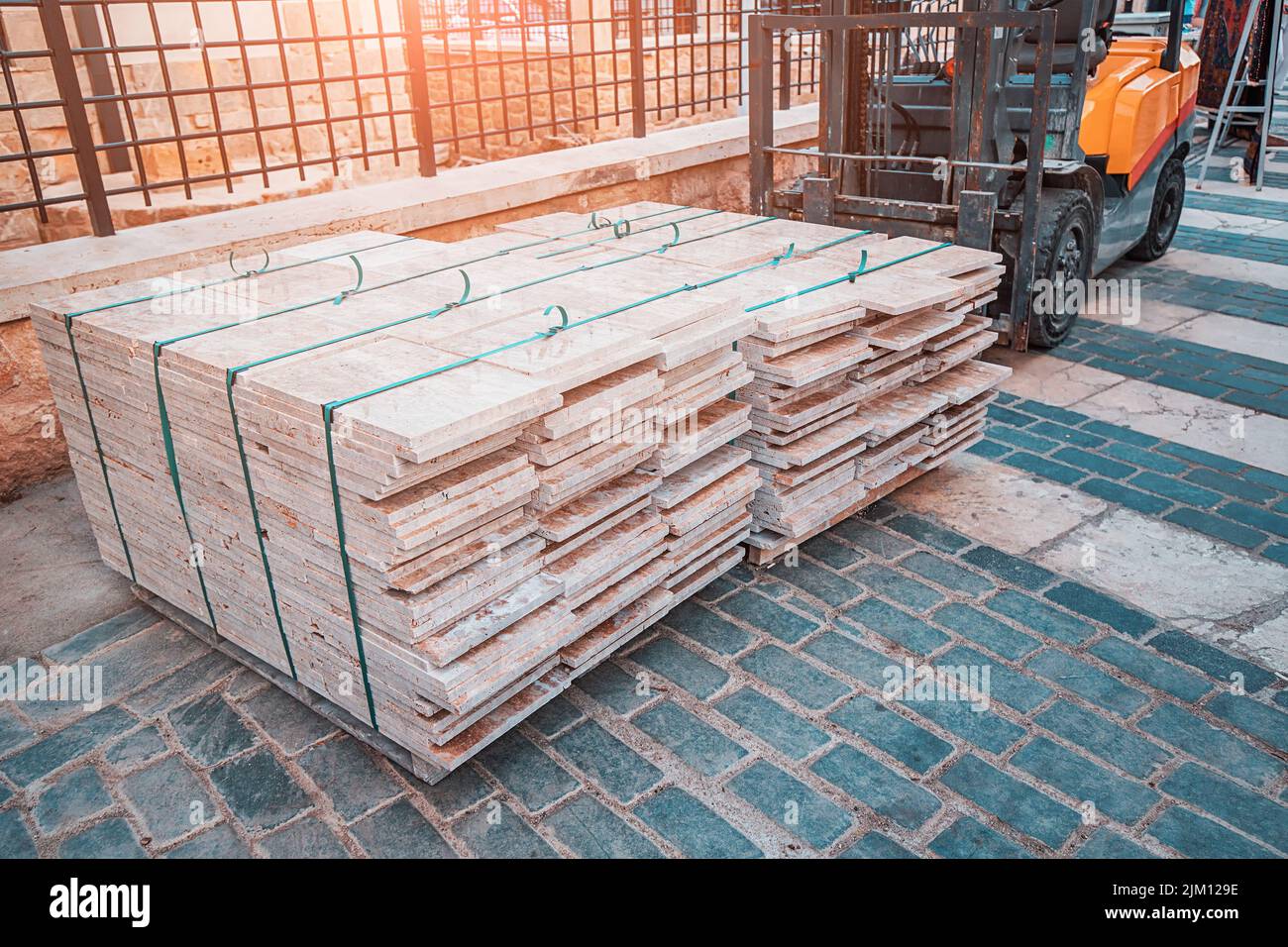 Forklift working with tiles cargo at construction site or warehouse ...