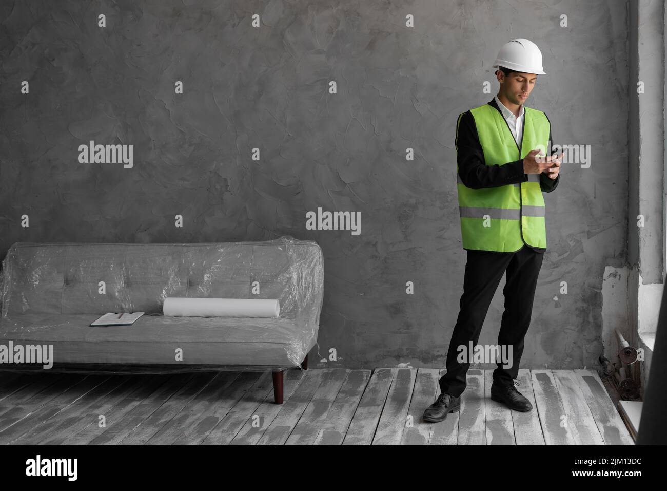 Muslim professional builder engineer with safety helmet using phone ...