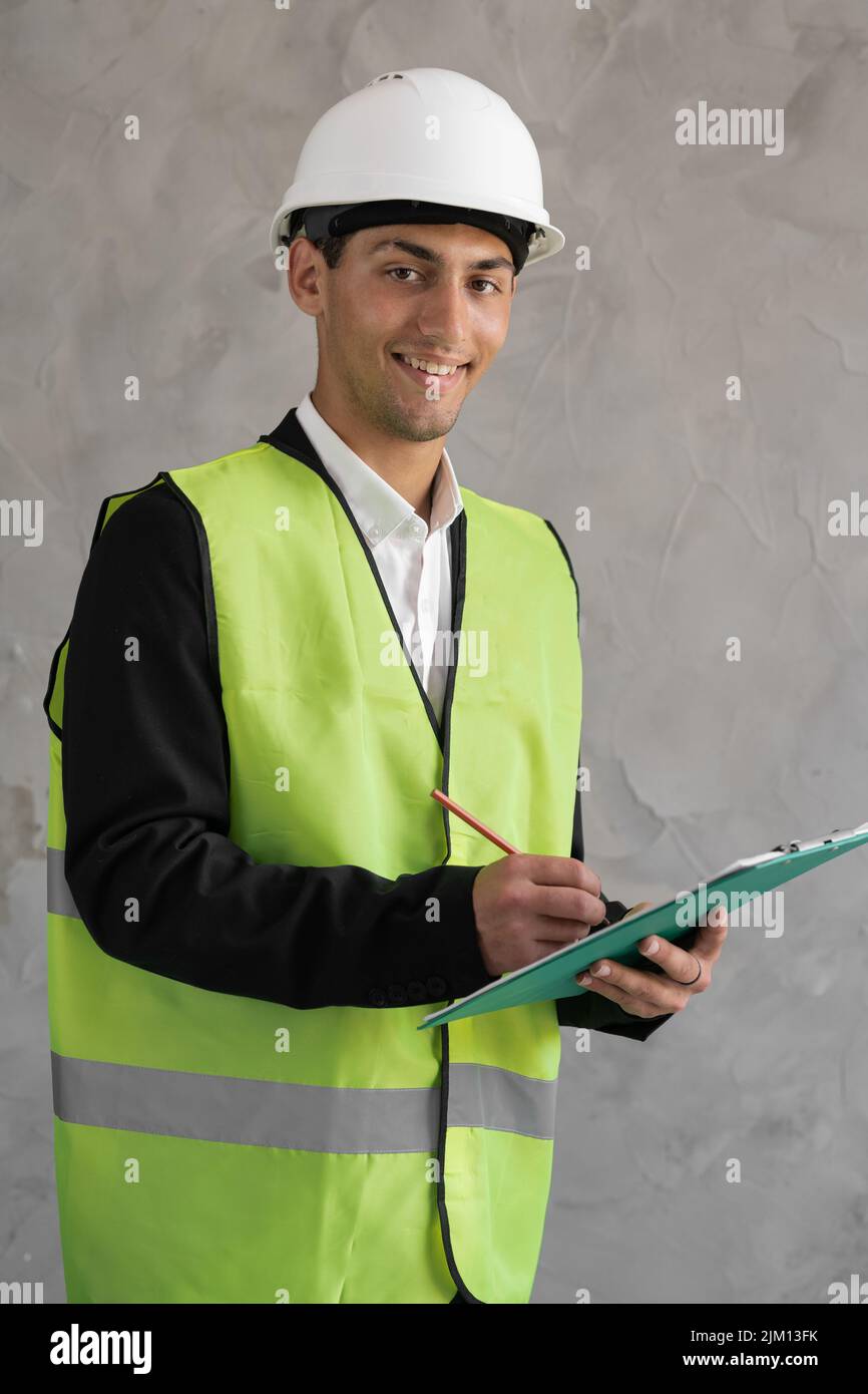 Muslim young engineer taking note on clipboard, portrait of an engineer ...