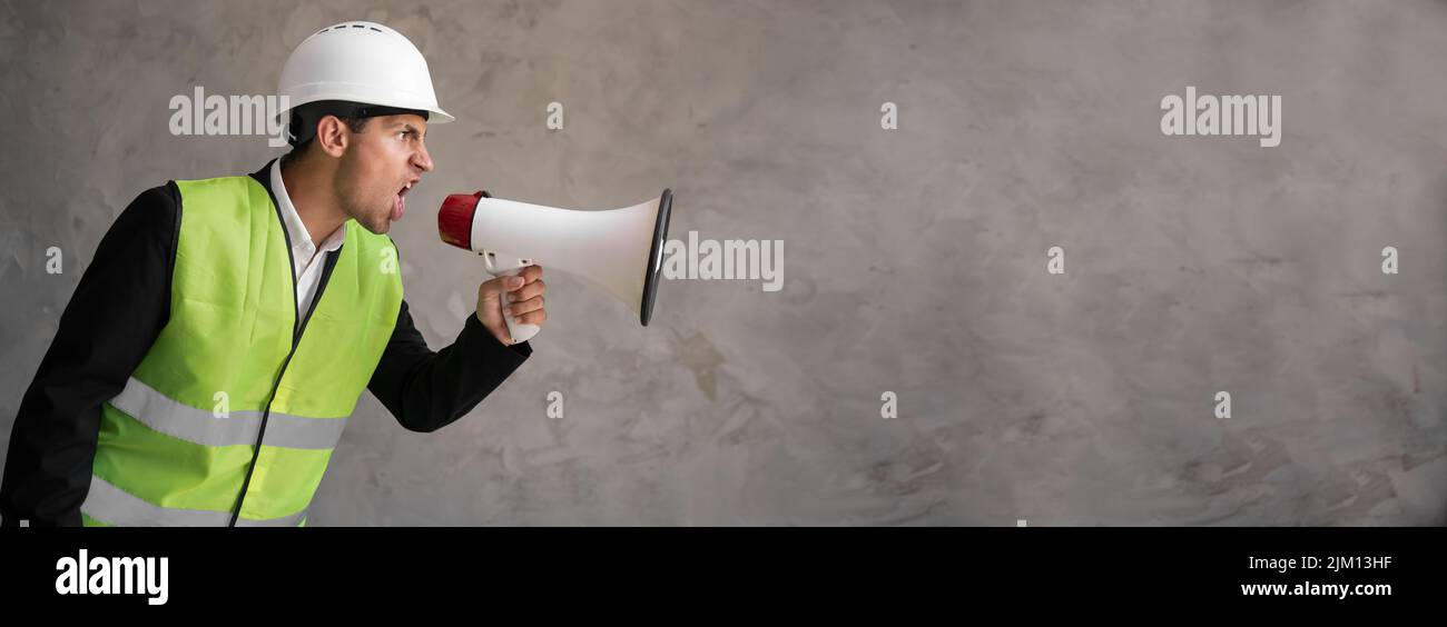 Muslim foreman shouting over grey background. Handsome happy ...