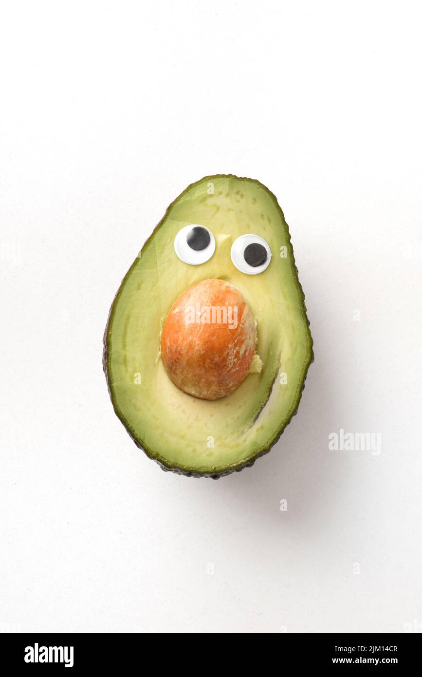 Fresh funny avocado inside with face on white isolated background ...