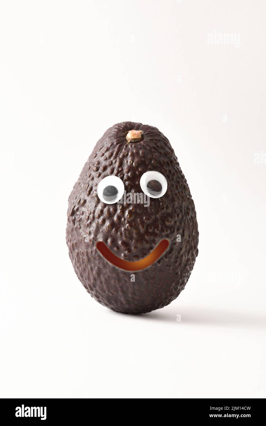 Fresh avocado with face on white isolated background. Fruit and ...