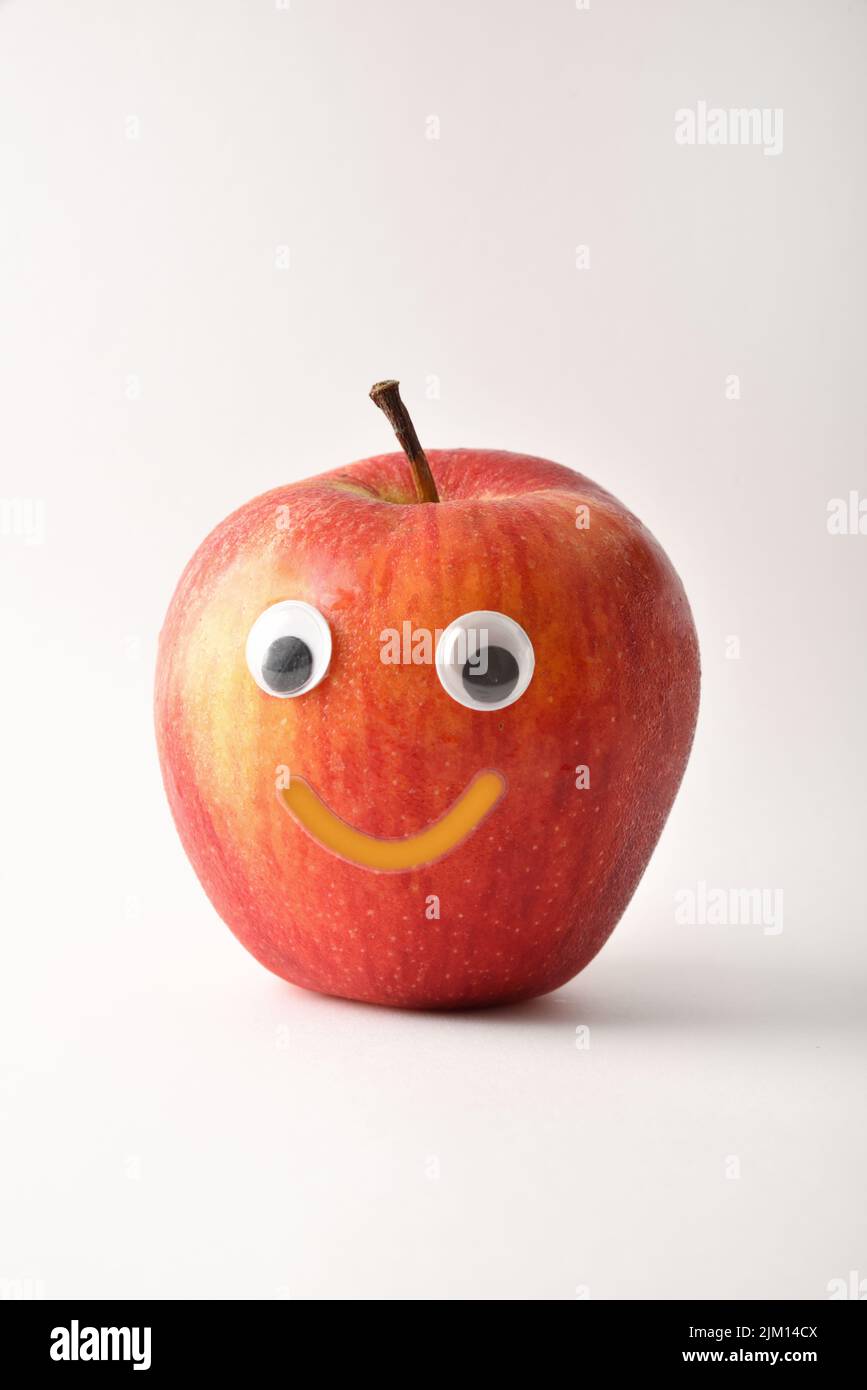 Healthy red apple with face on white isolated background. Fruits and ...