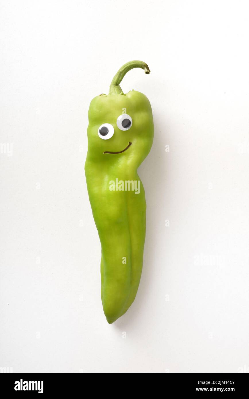 Fresh green pepper with face on white isolated background. Fruits and ...