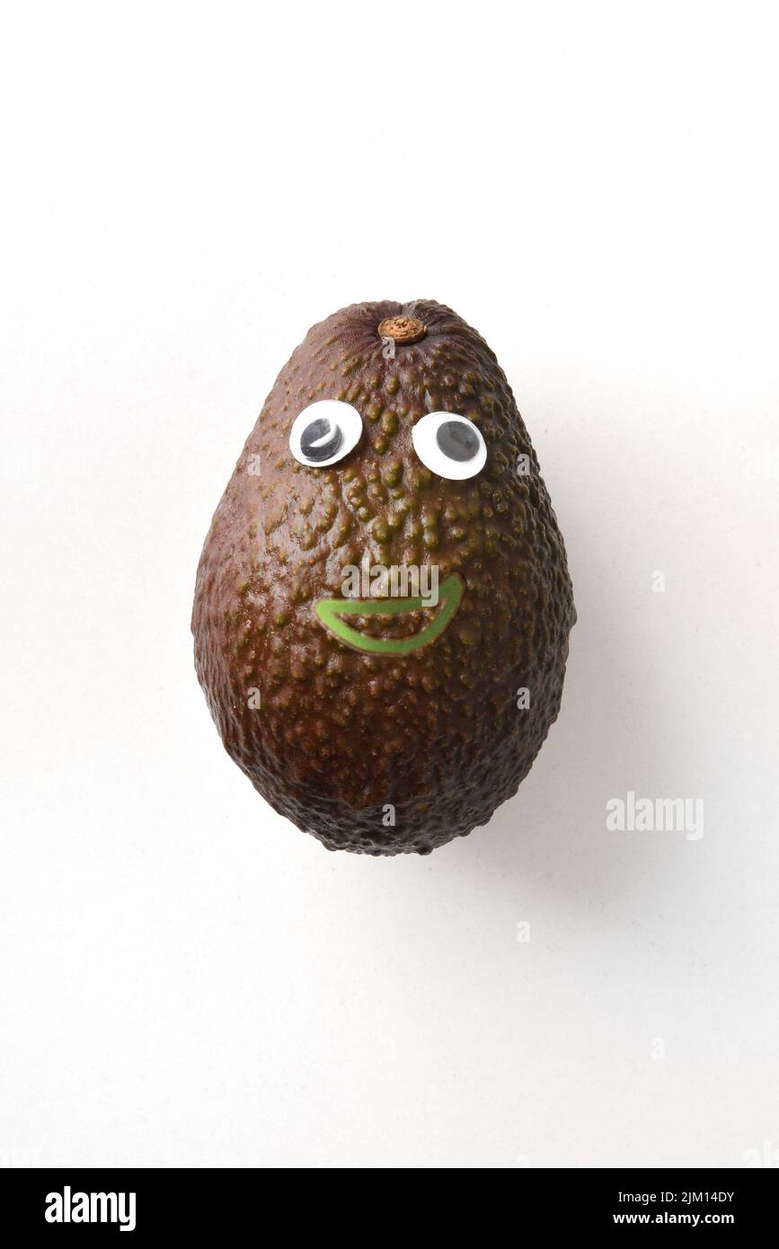 Fresh avocado with face on white isolated background. Fruit and ...