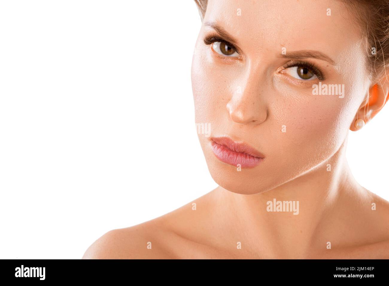 Close-up portrait of an angry young woman. She stares into the camera ...