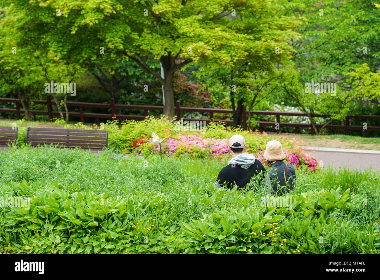 Mother and son, flower garden scenery Stock Photo - Alamy