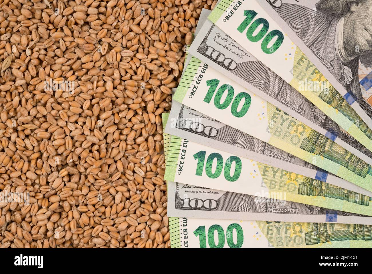Hundred dollars banknotes and euro money over wheat grain. Global food ...