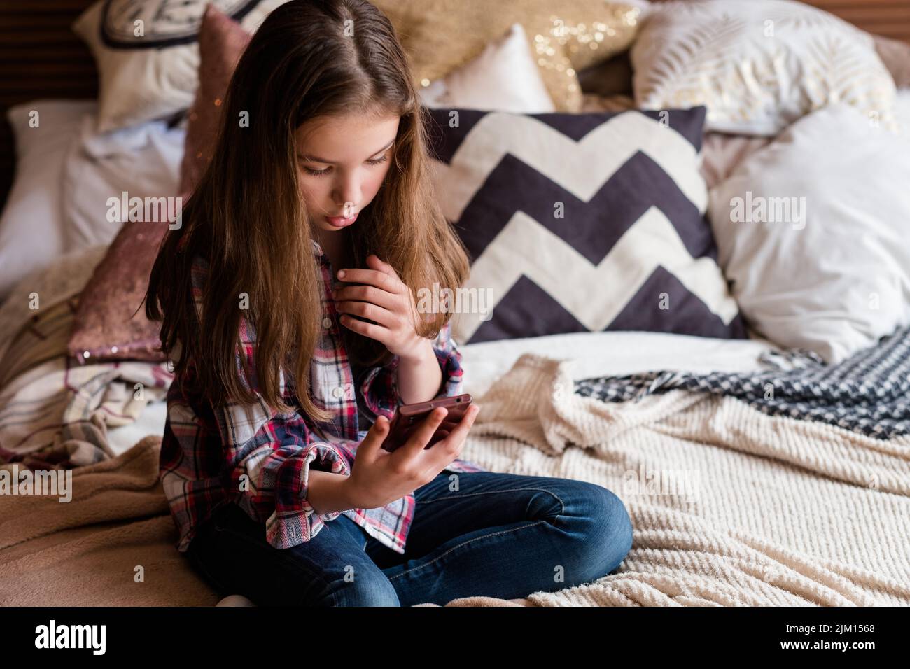 idle child leisure girl using mobile phone home Stock Photo - Alamy