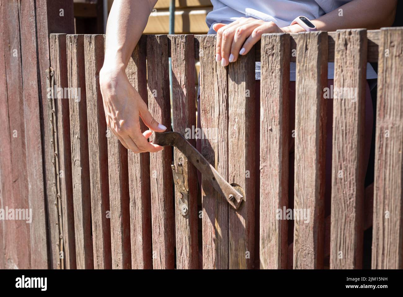 female hand opens the bolt on the tile Stock Photo - Alamy