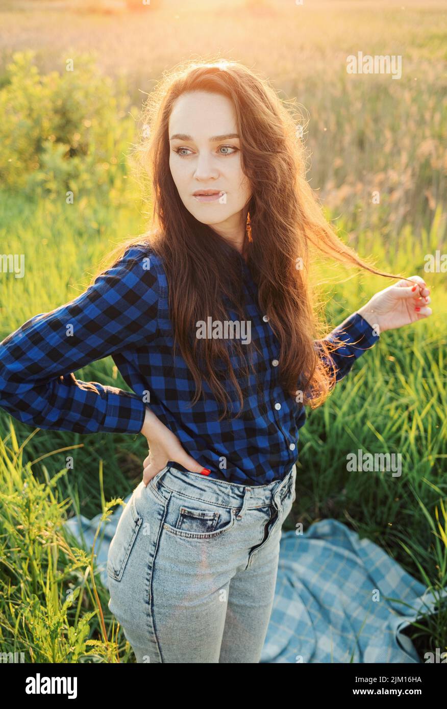 Portrait Of A Beautiful Young Woman On Meadow Watching The Sunset