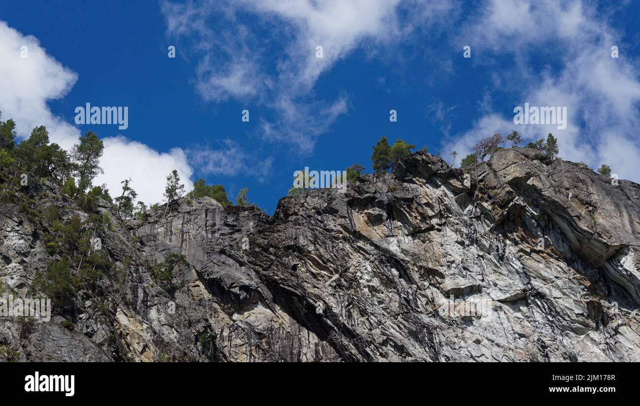 High cliff in the nature of Norway landscape with blue sky clouds in ...