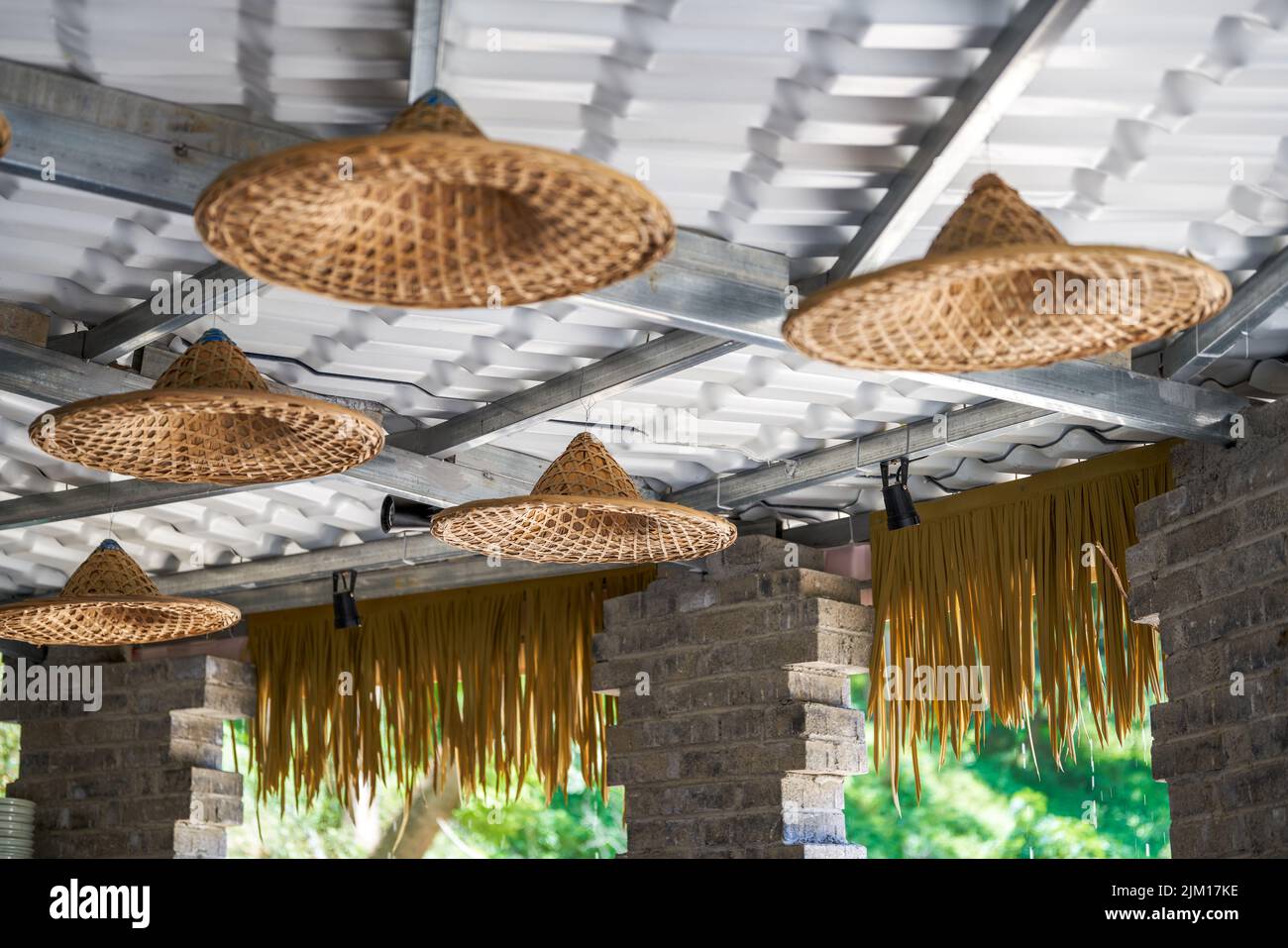 Rural house ceiling covered with straw hat decoration Stock Photo - Alamy