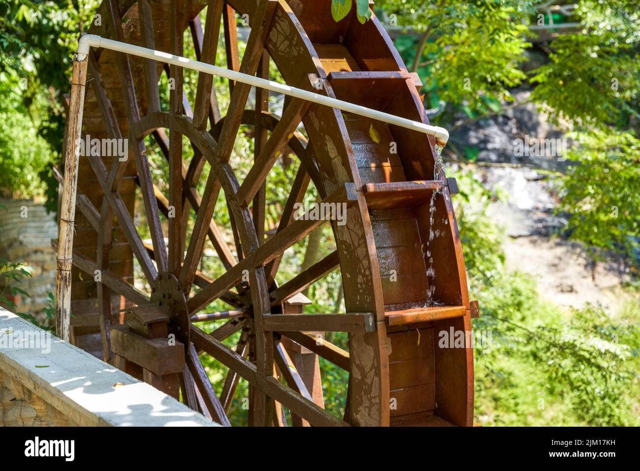 Wooden waterwheel for outdoor irrigation Stock Photo - Alamy