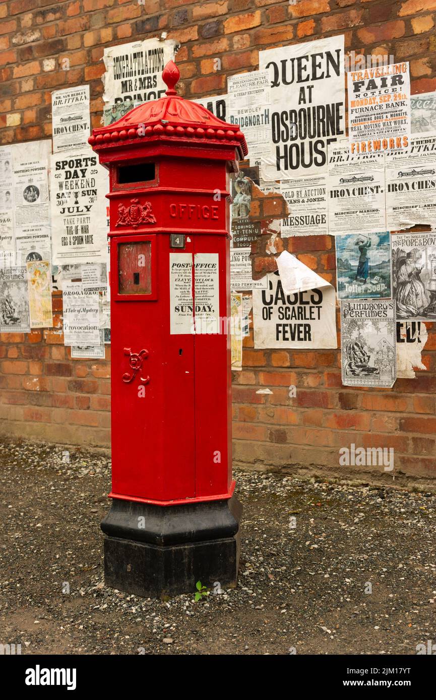 A Victorian Post Box with period posters on the wall behind at Blists ...