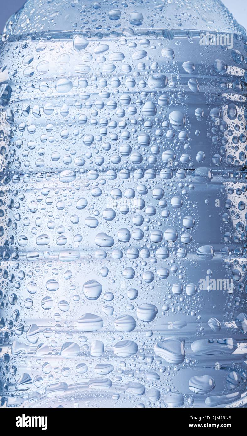 Surface of water bottle covered with condensation of drops closeup ...
