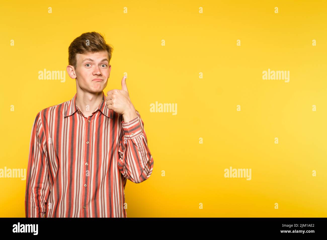 approving smiling man showing thumb up gesture Stock Photo - Alamy